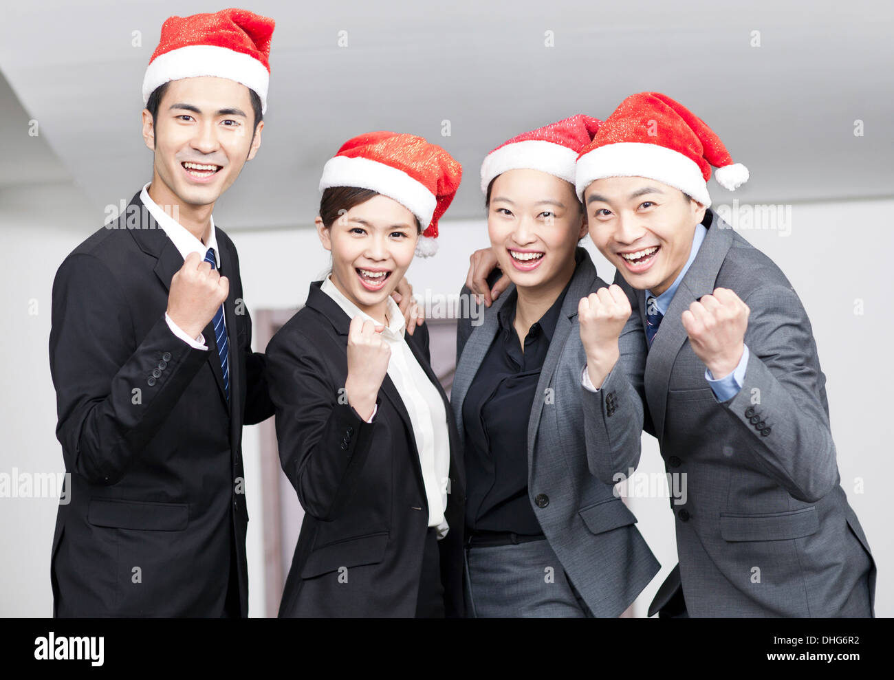 Group of young business people cheering,wearing Christmas hat Stock ...