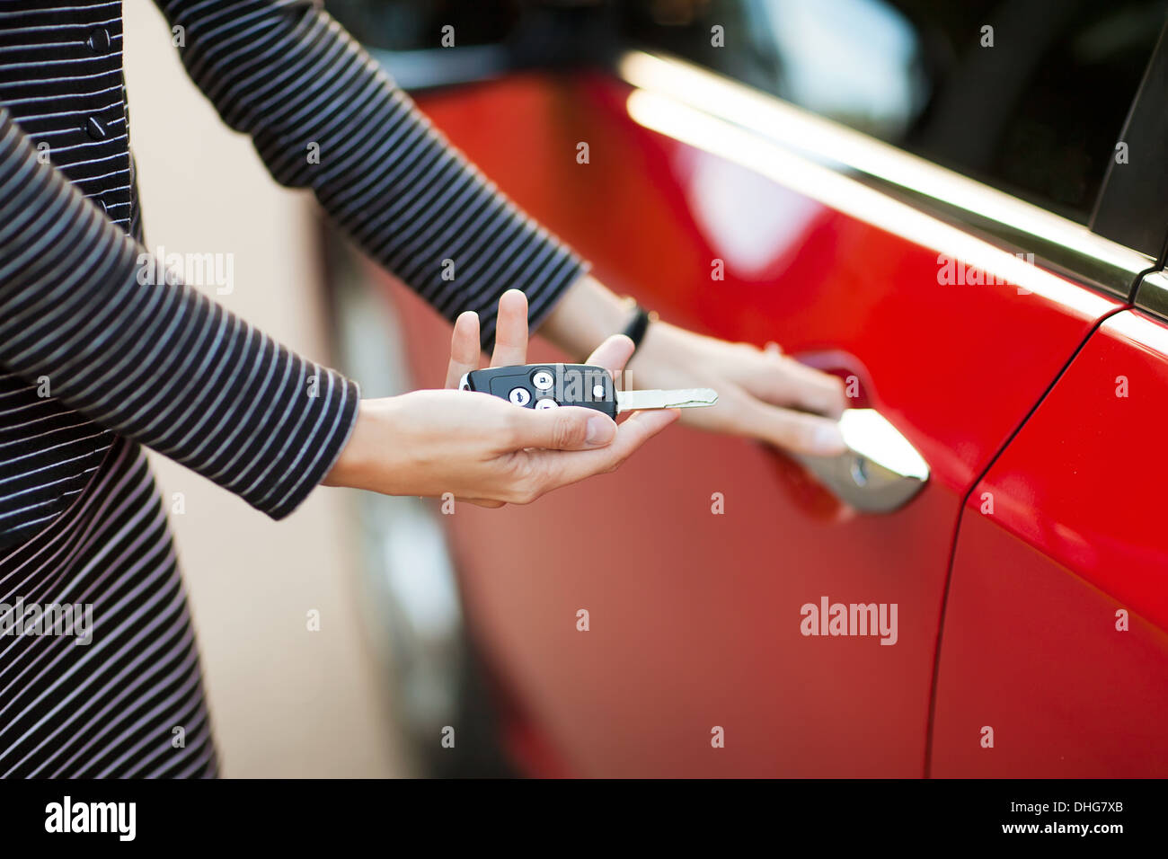Beautiful young girl with car key in hand and opens the car Stock Photo ...