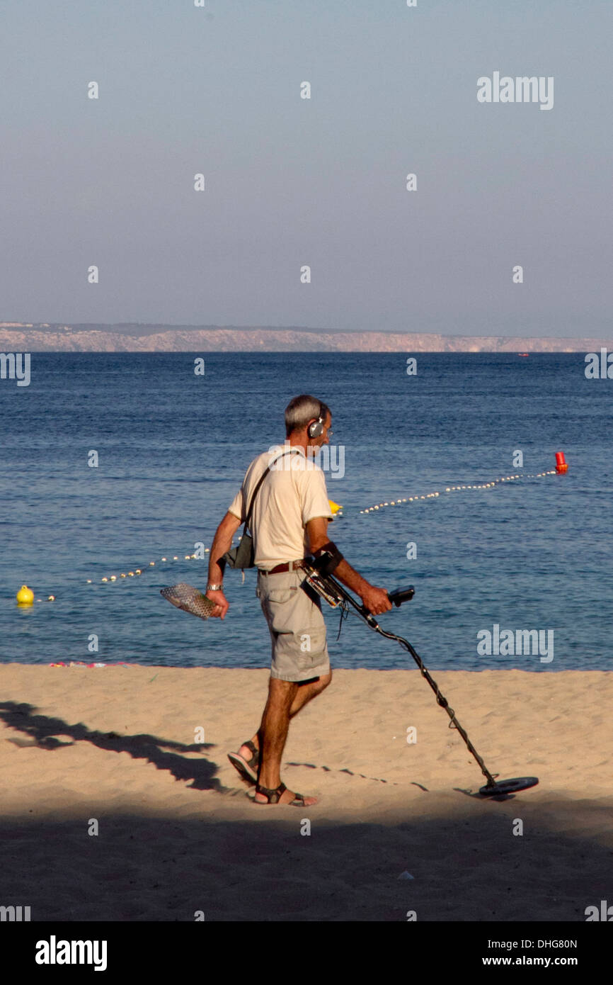 A man uses a metal detector on beach of Palmanova Mallorca Spain Stock ...