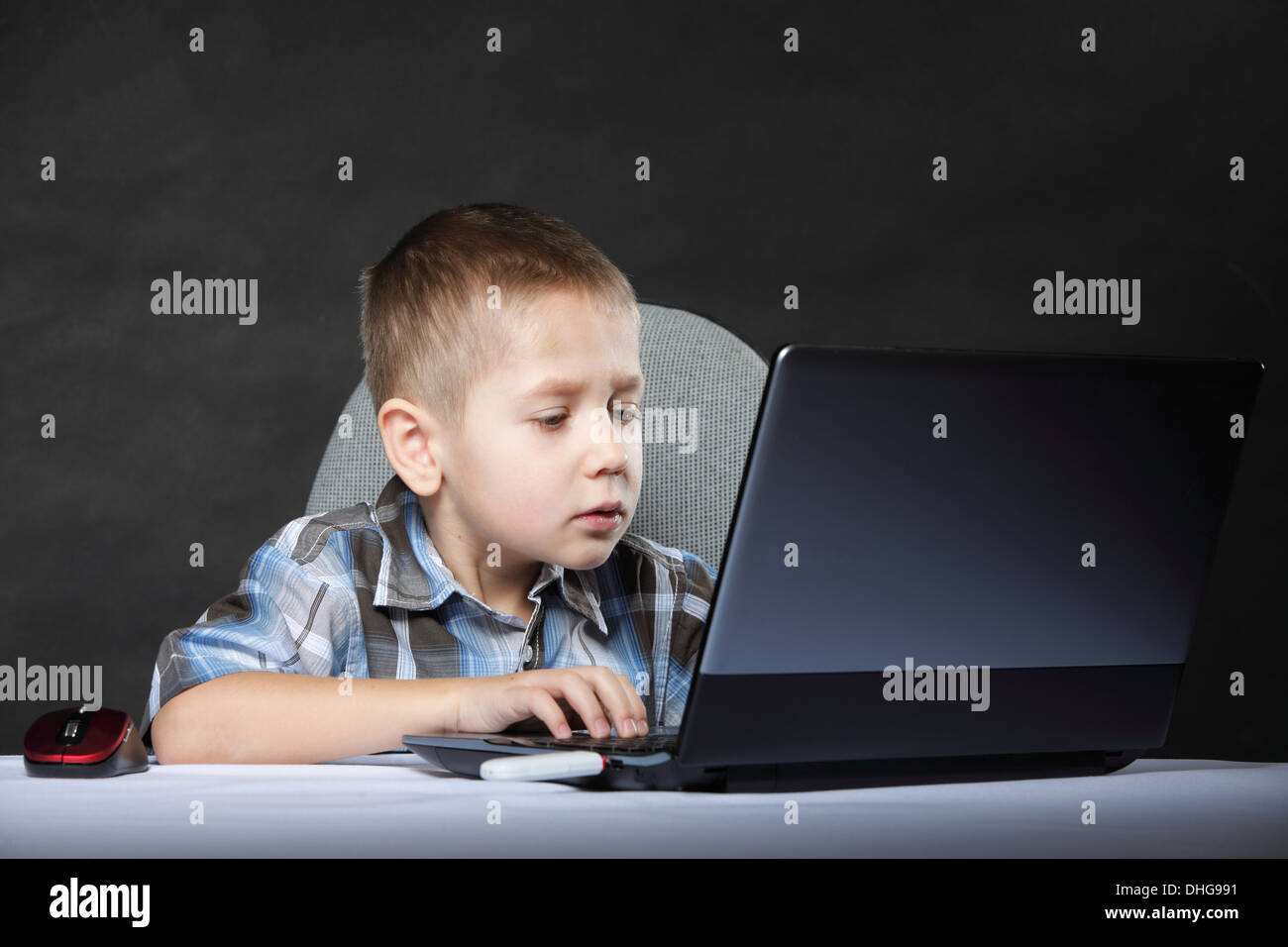 Computer addiction child boy with laptop notebook black background ...