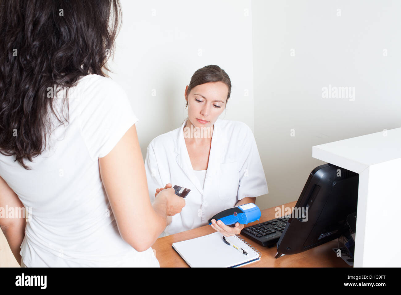 Female patient paying for medical treatment with credit card Stock ...