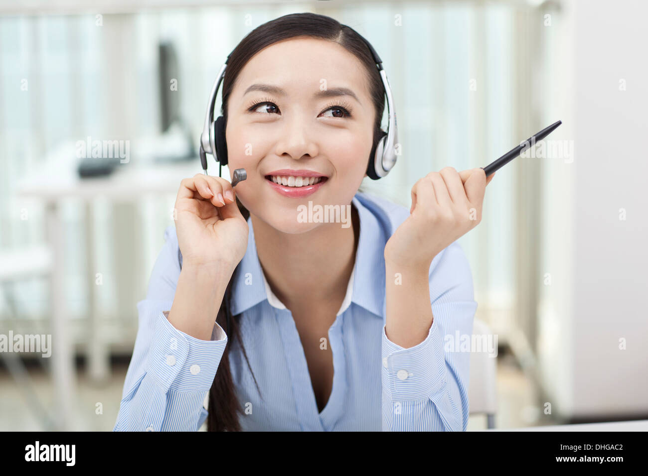 Female office worker wearing headset,portrait Stock Photo - Alamy