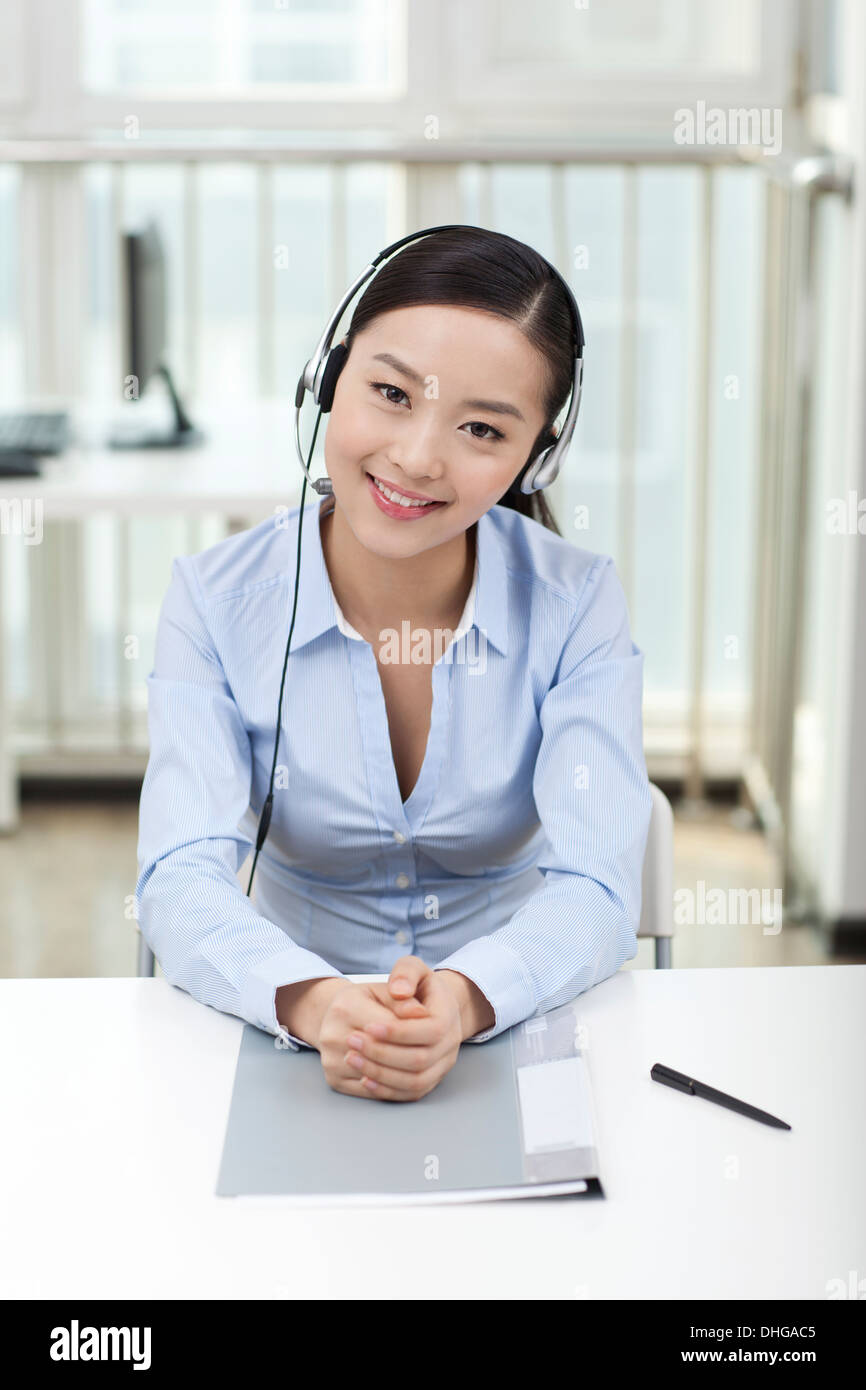 Female office worker wearing headset,portrait Stock Photo - Alamy