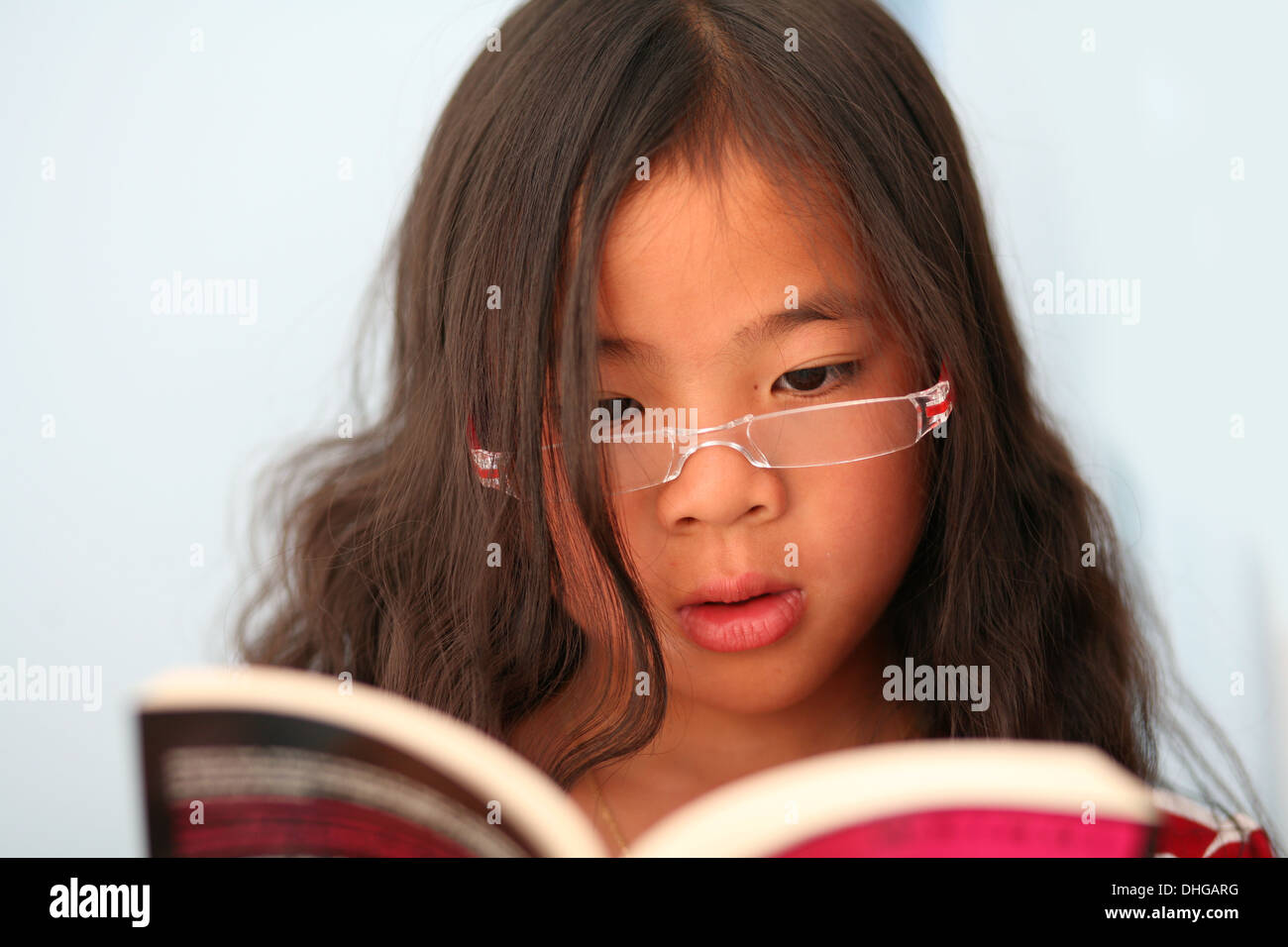 child reading a book ans studying (Chinese child Stock Photo - Alamy