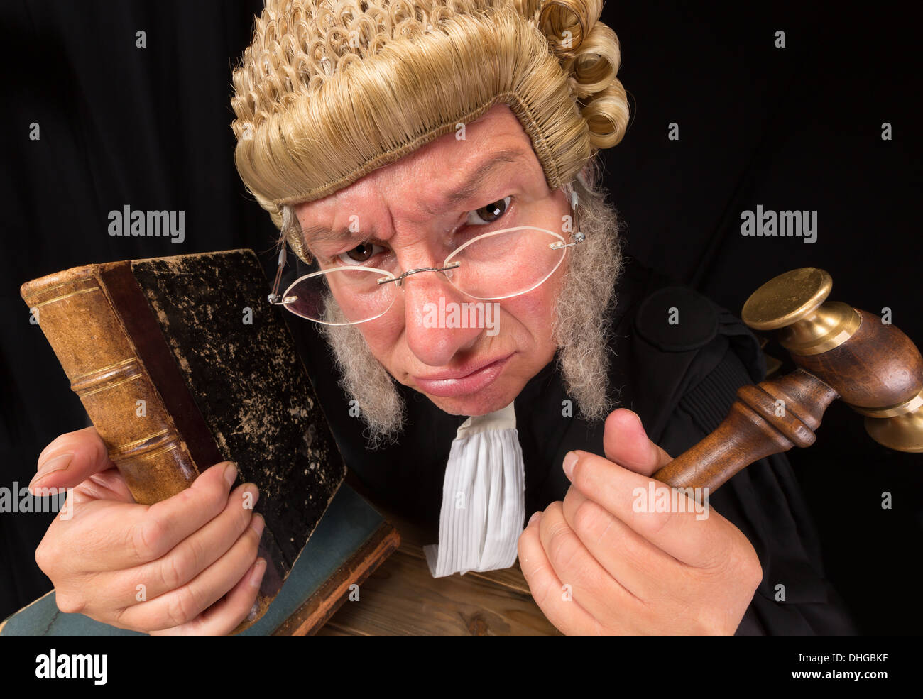 Grumpy old judge in extreme wide angle closeup with hammer and wig ...