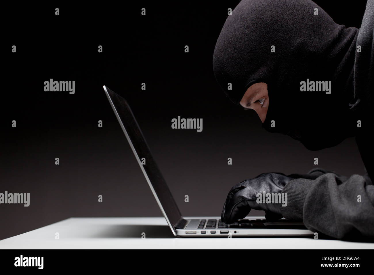 Computer hacker in a balaclava Stock Photo - Alamy