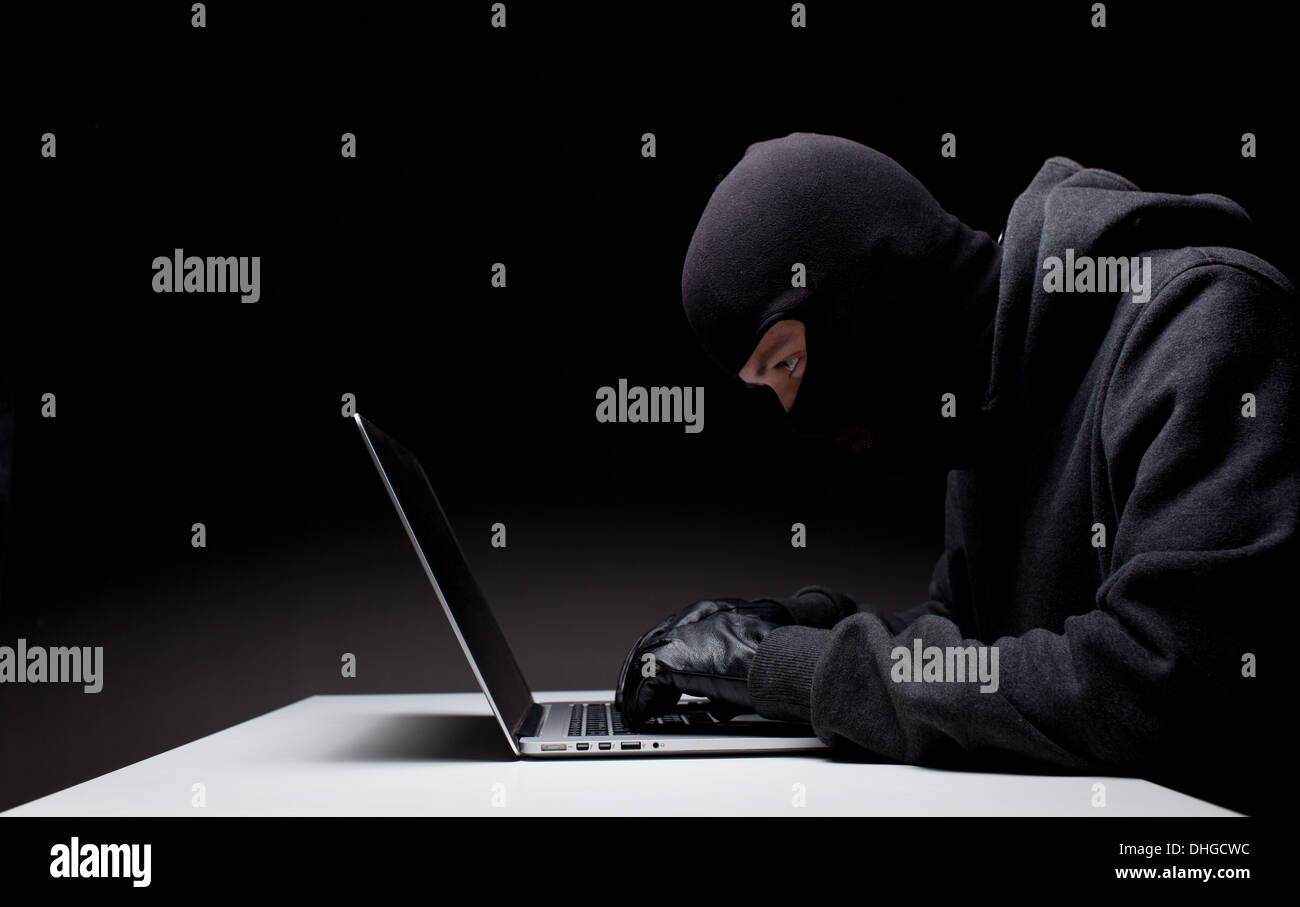 Computer hacker in a balaclava Stock Photo - Alamy
