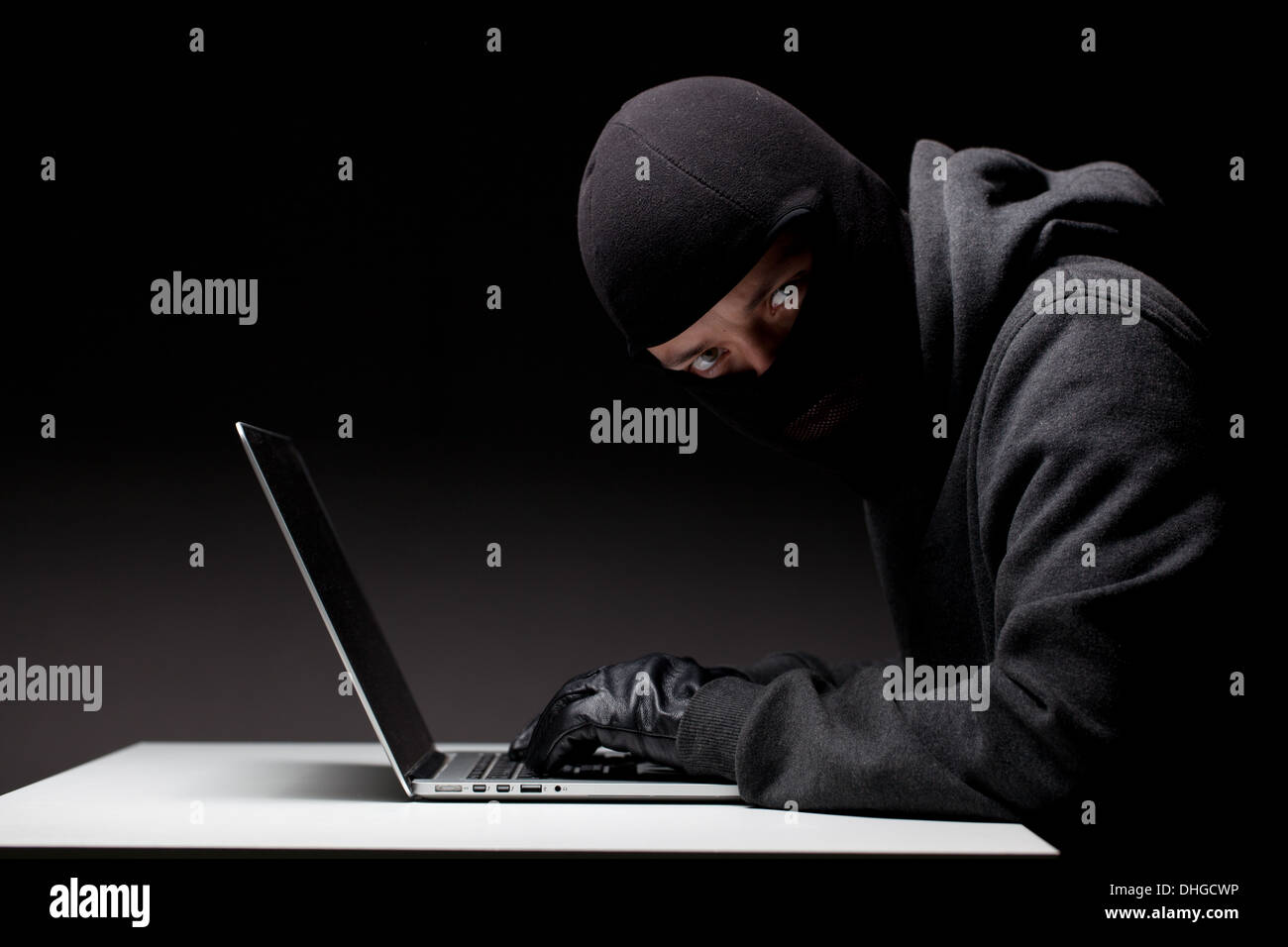 Computer hacker in a balaclava Stock Photo - Alamy