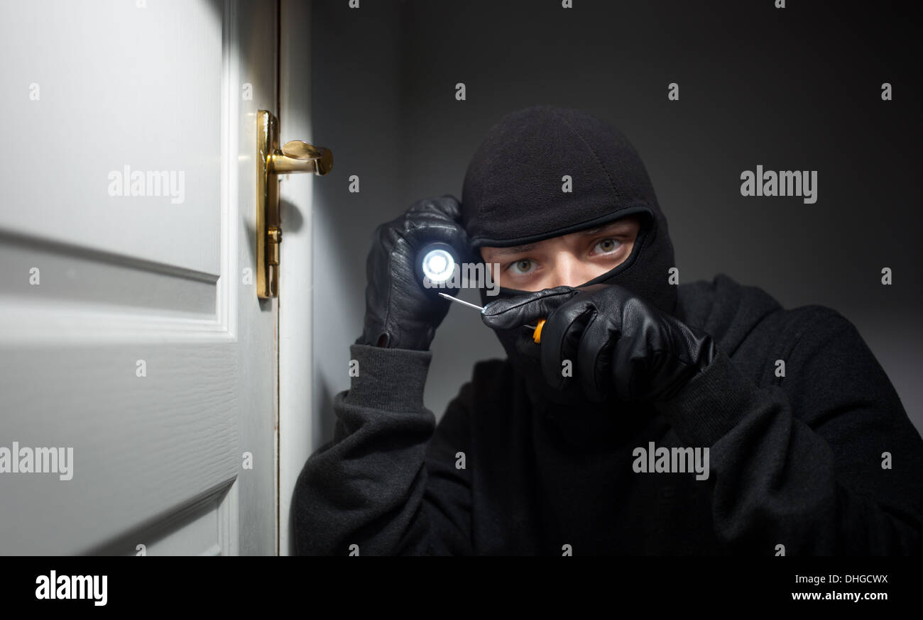Thief Burglar opening door Stock Photo - Alamy
