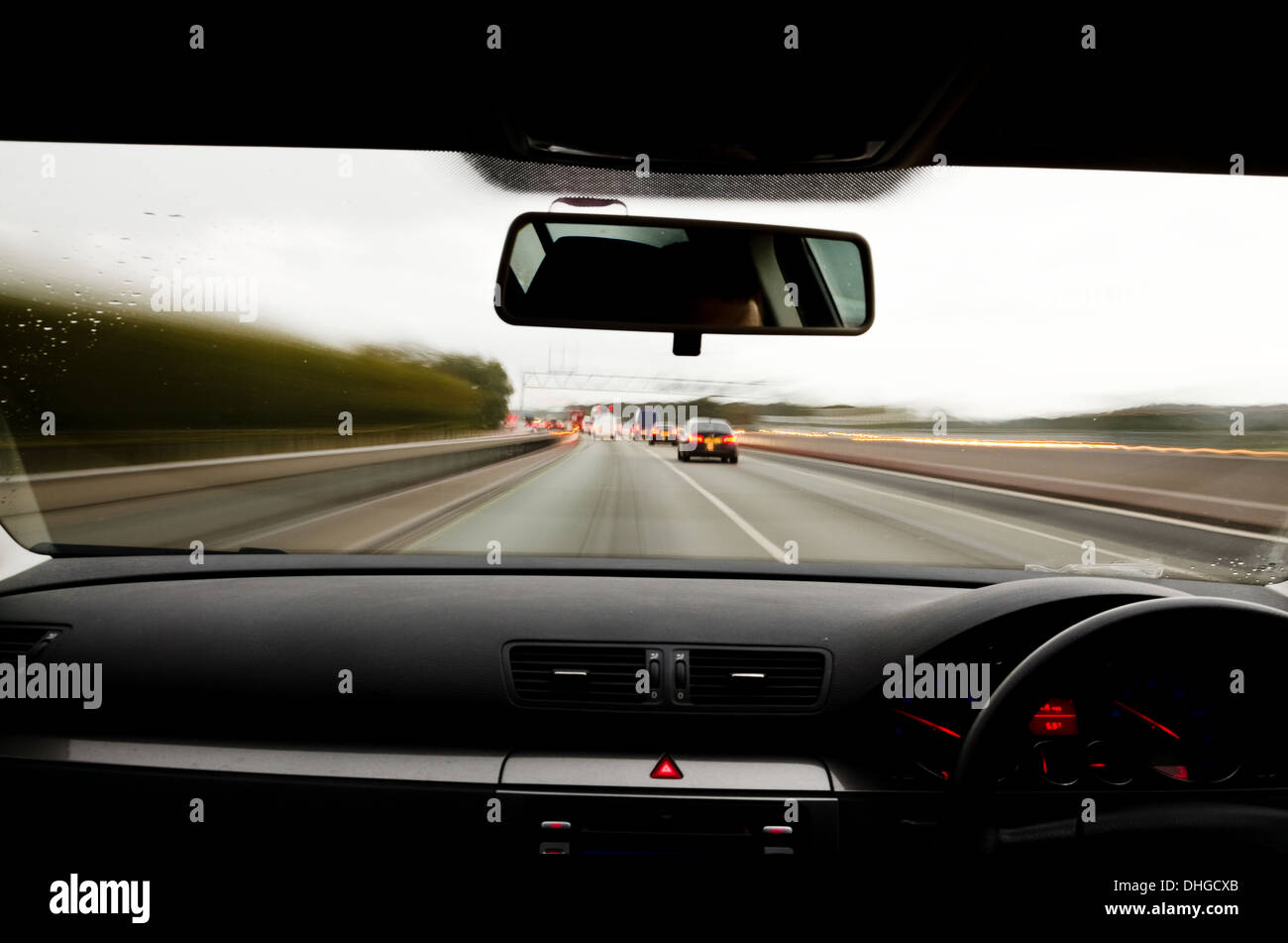 view through the windscreen of a moving car with motion blur and ...