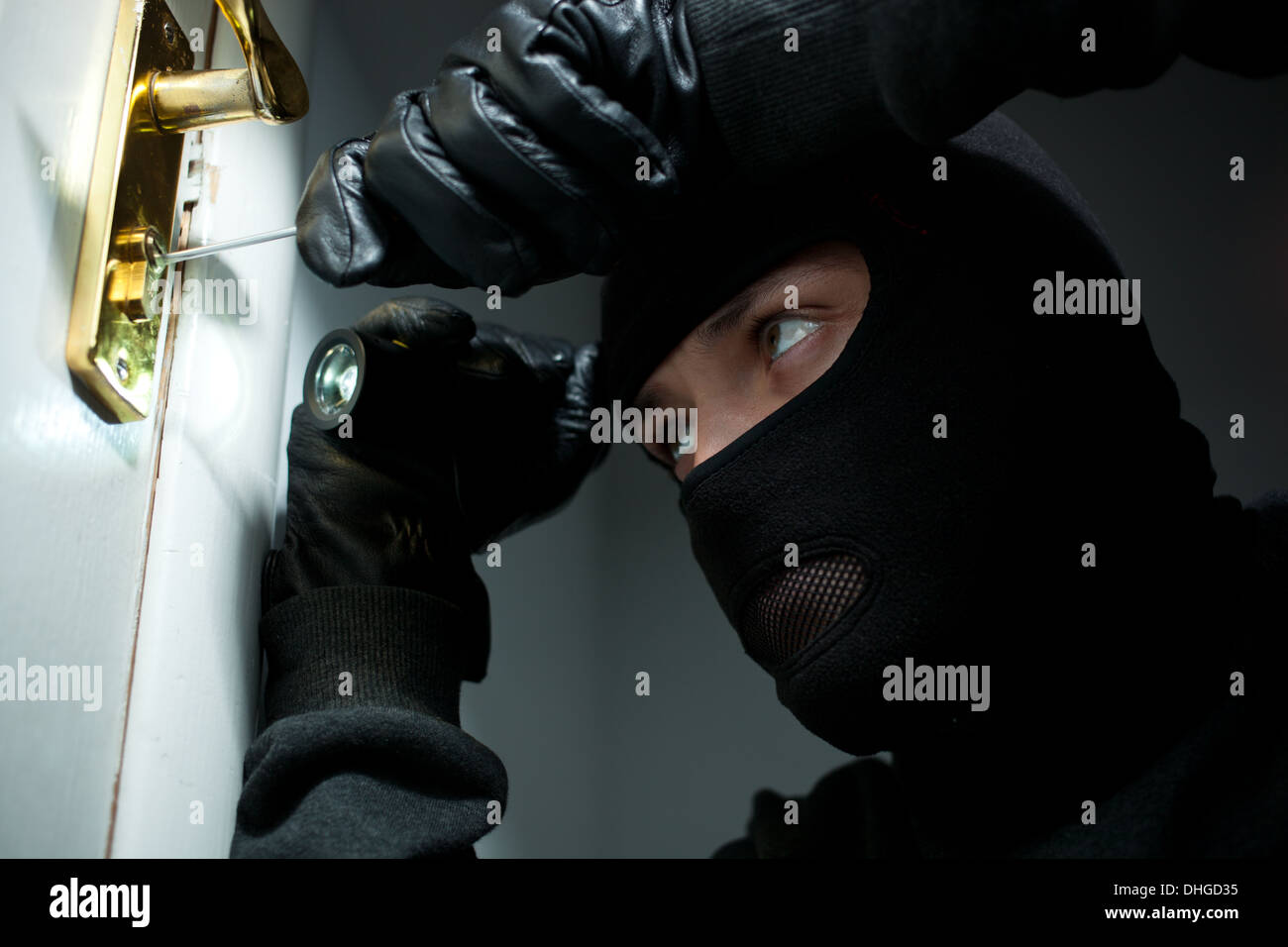 Thief Burglar opening door Stock Photo - Alamy