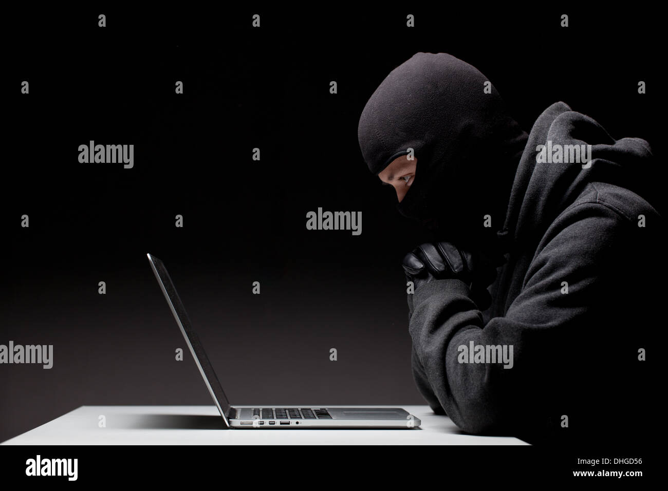 Computer hacker in a balaclava Stock Photo - Alamy