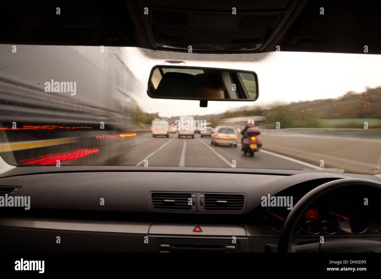 view through the windscreen of a moving car with motion blur and ...