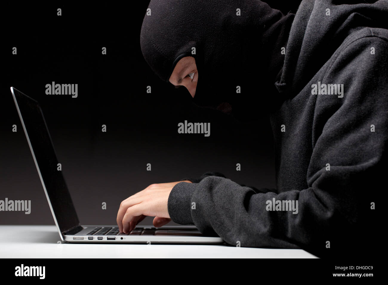 Computer hacker in a balaclava Stock Photo - Alamy