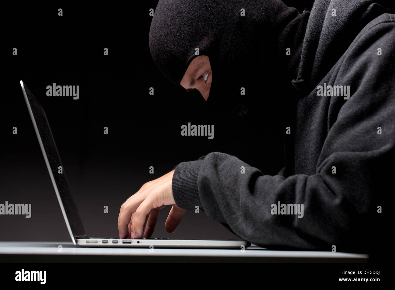 Computer hacker in a balaclava Stock Photo - Alamy