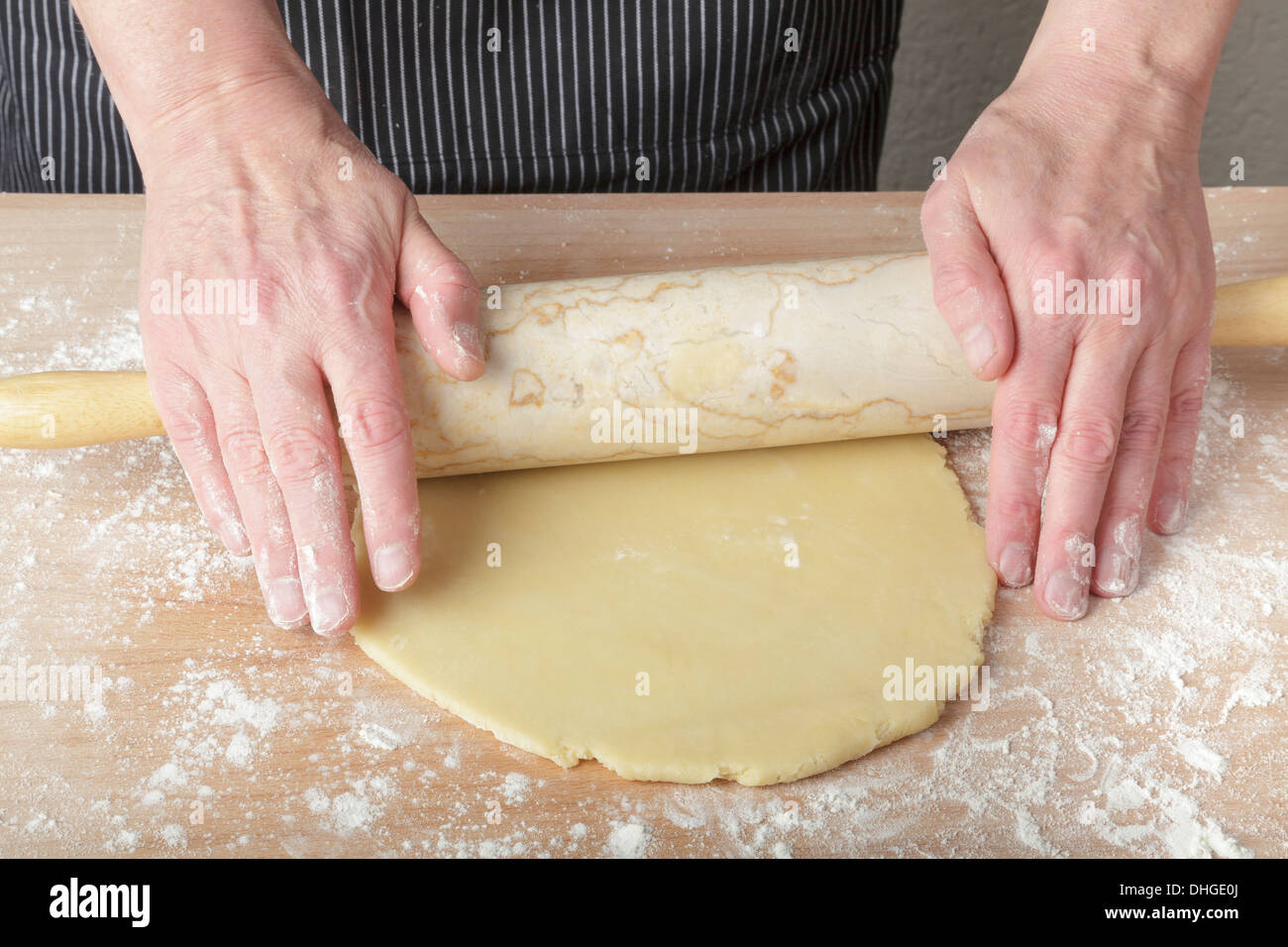 rolling out pastry on floured surface Stock Photo - Alamy