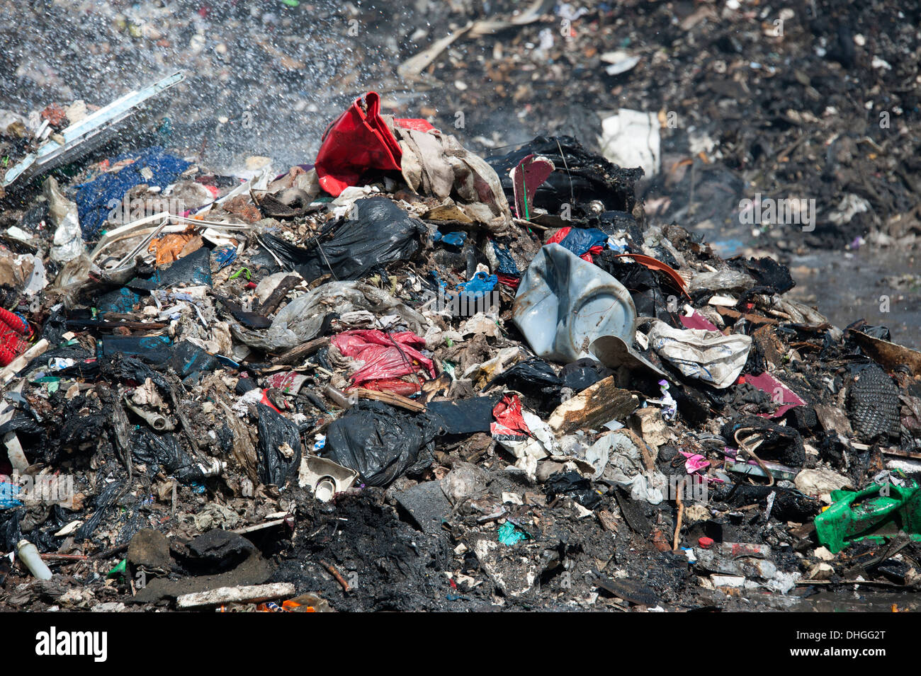 Household waste rubbish on fire smouldering Stock Photo - Alamy