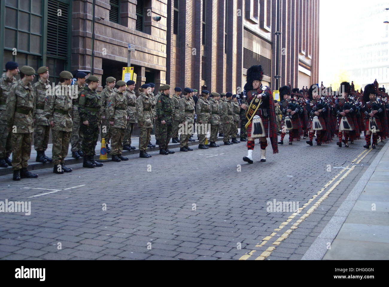 A Pipe Band marches into Manchester UK to join the Remembrance Parade ...