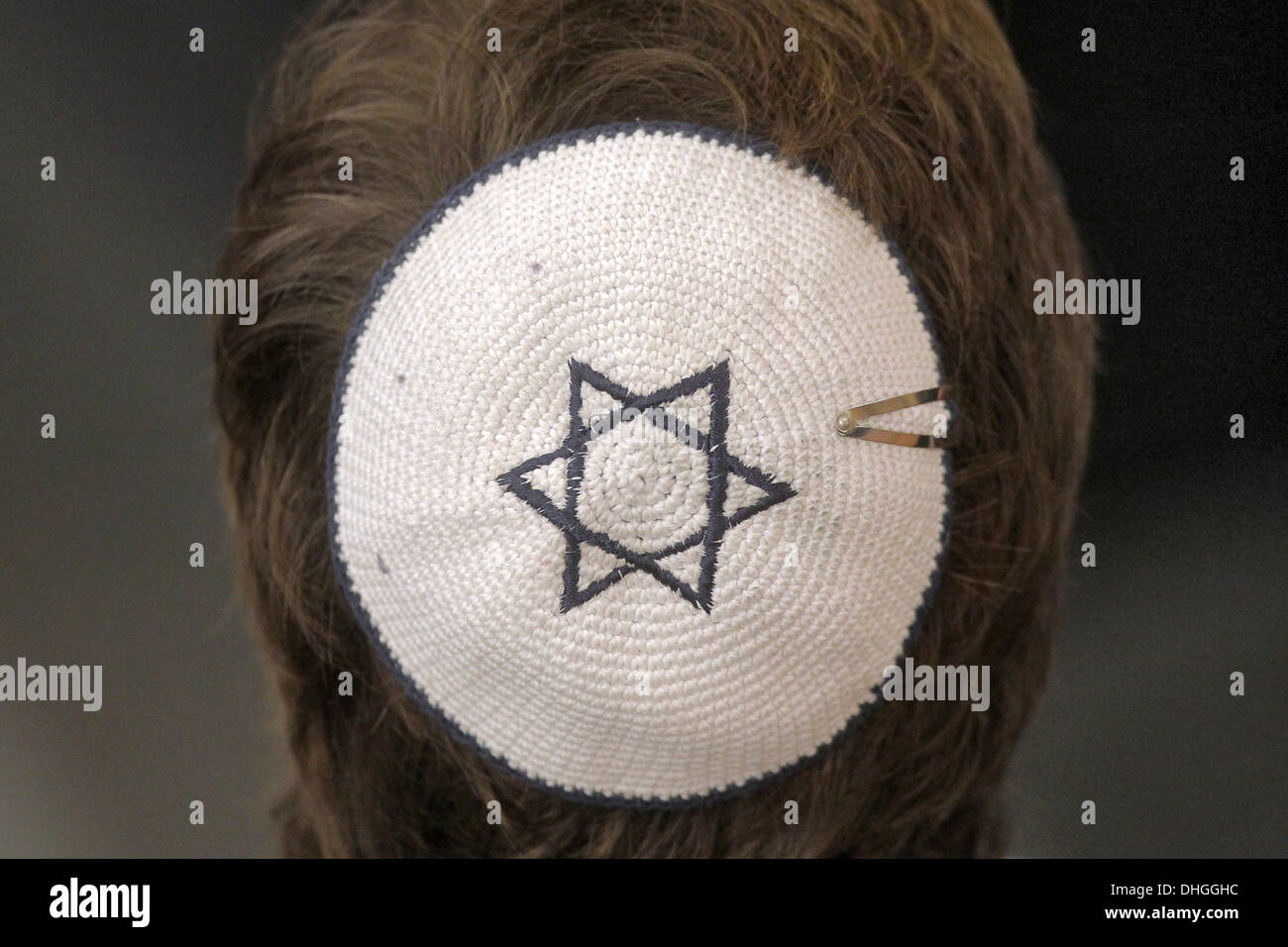 Mainz, Germany. 9th Nov, 2013. A man wears a kippa which shows the star ...