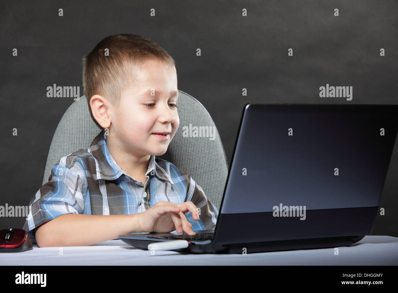 Computer addiction child boy with laptop notebook black background ...