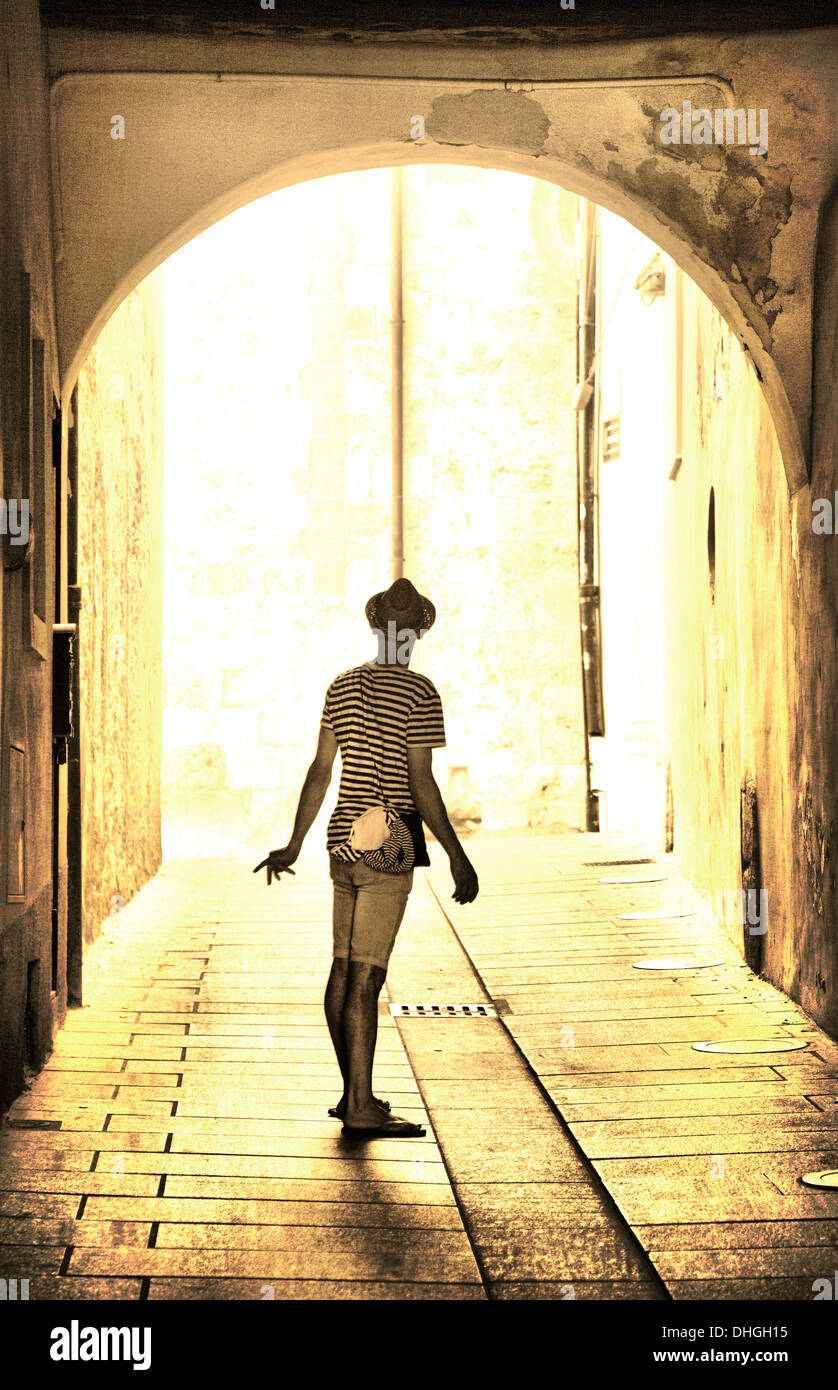 Man in Stripes Standing in Arched Lane Stock Photo - Alamy