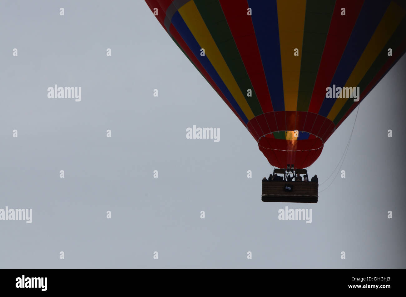 Hot air balloon in the sky showing basket and fire Stock Photo - Alamy