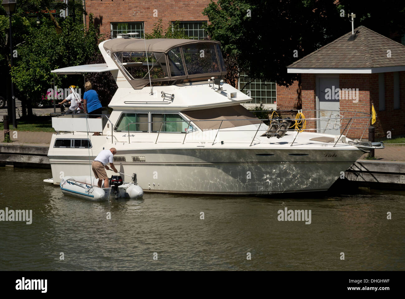Man cleaning cabin cruiser Stock Photo - Alamy