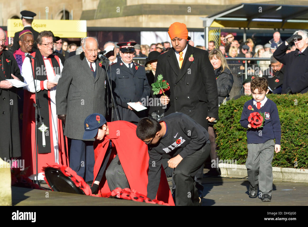 Boys lay wreaths on behalf of the young people of Manchester at the ...