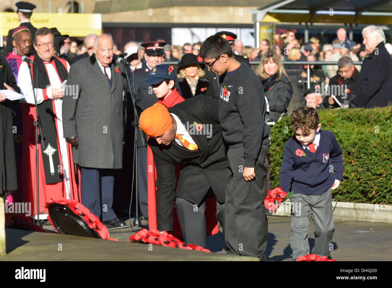 Boys lay wreaths on behalf of the young people of Manchester at the ...