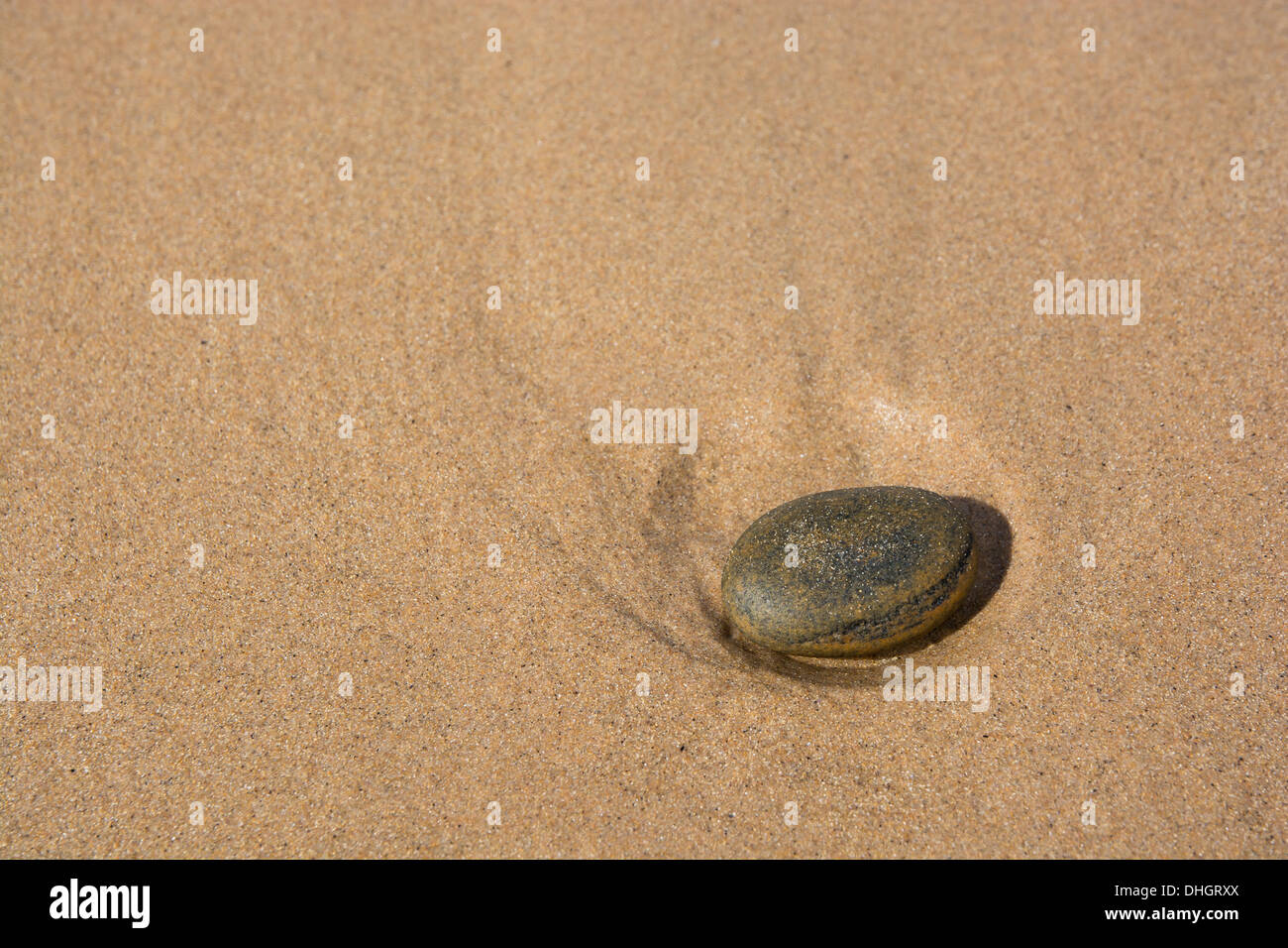 Wet Sand And Isolated Stone Stock Photo - Alamy