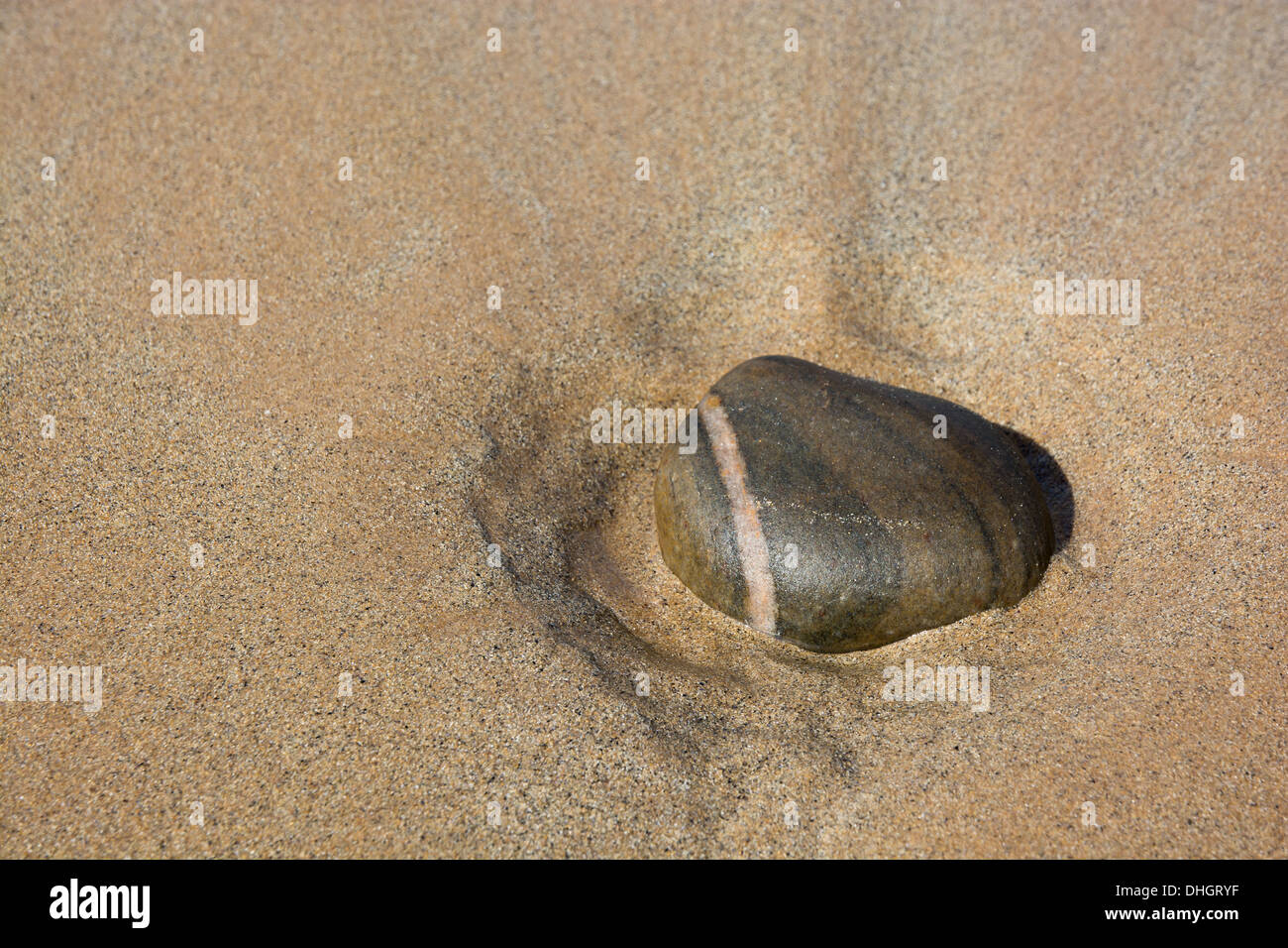 Wet Sand And Isolated Stone Stock Photo - Alamy