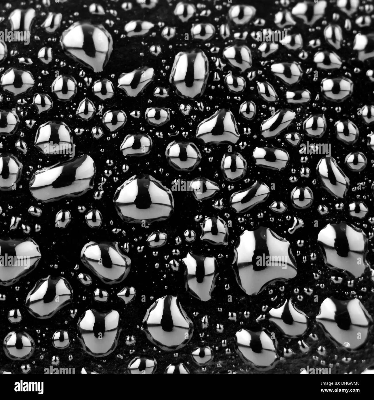 Silver liquid drops on black background Stock Photo - Alamy