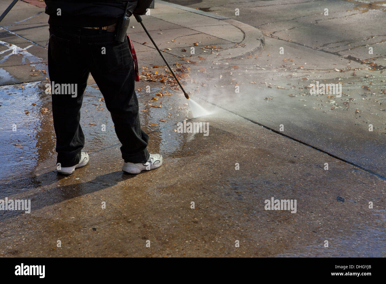 Man power washing walkway Stock Photo - Alamy