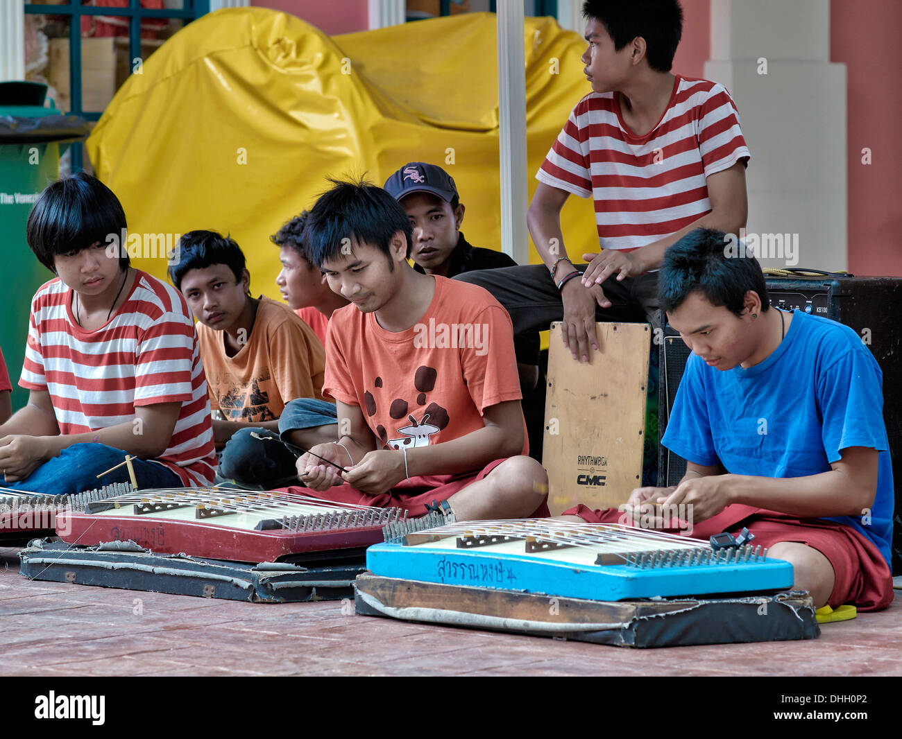 Thai youth band playing the Khim, a hammer dulcimer musical instruments ...