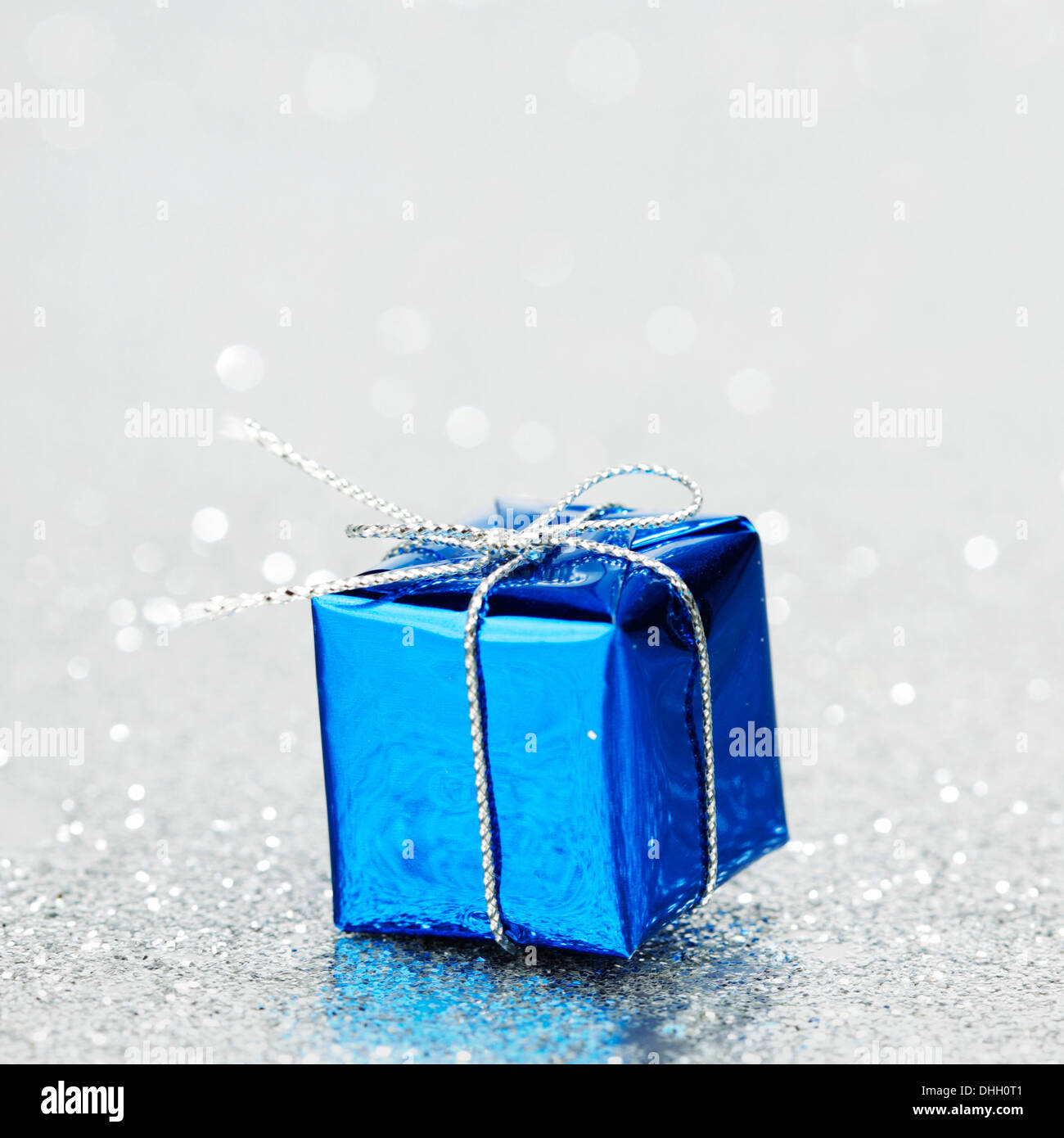 Blue Christmas gift box on shiny silver background Stock Photo - Alamy