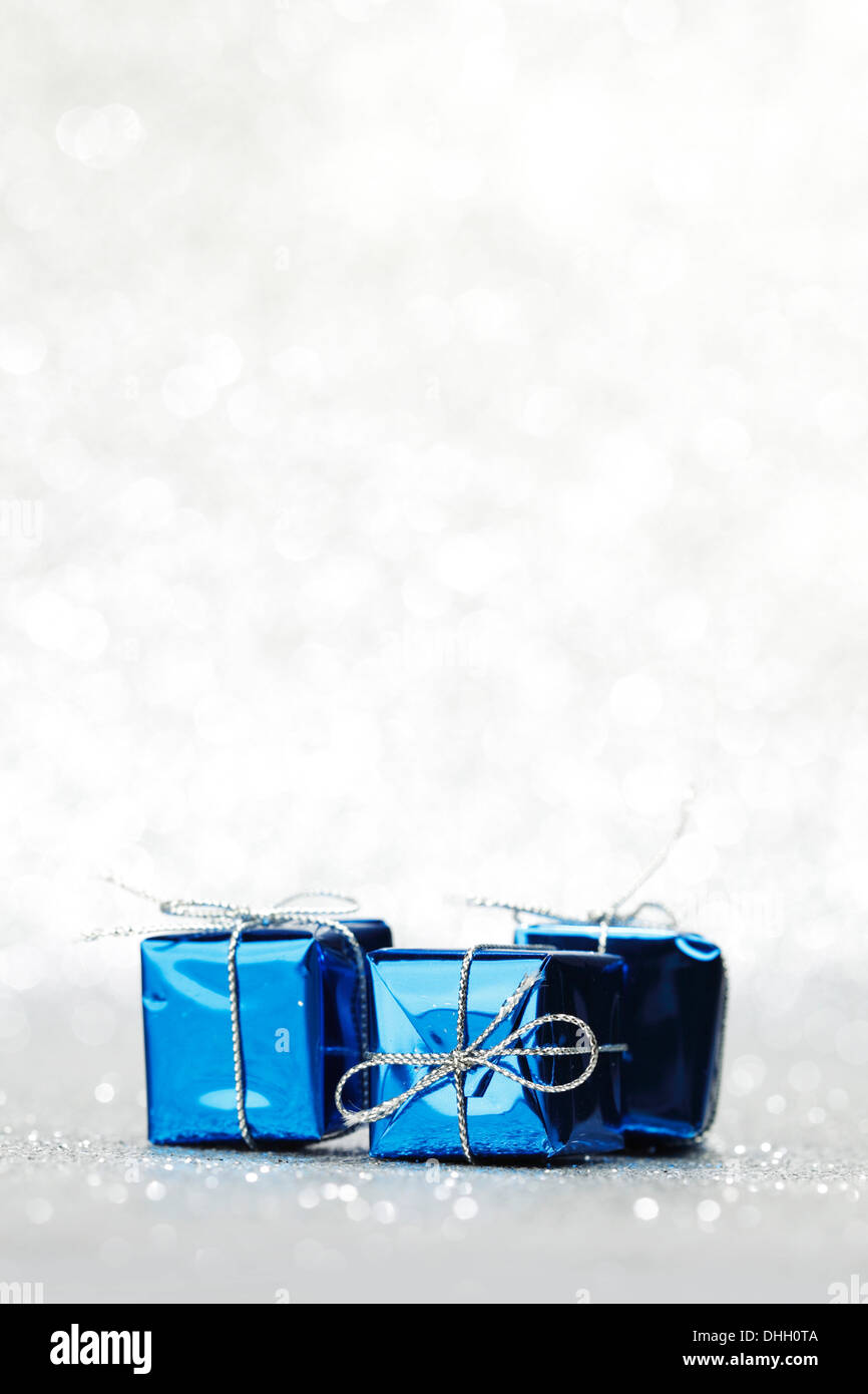 Blue Christmas gift boxes on shiny silver background Stock Photo - Alamy