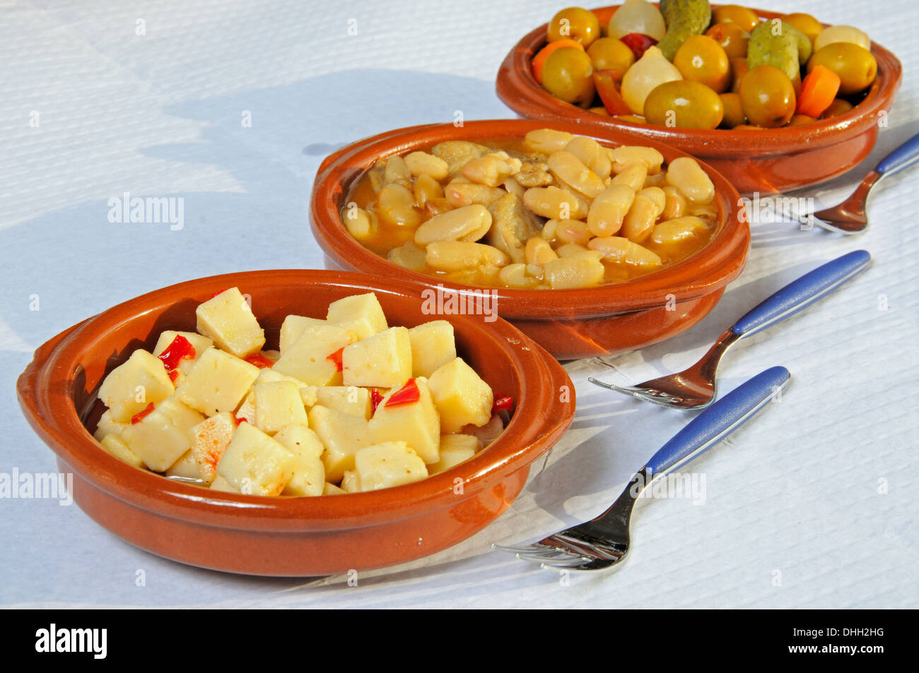 Selection of tapas - From front to back: Cubed Manchego cheese in olive ...