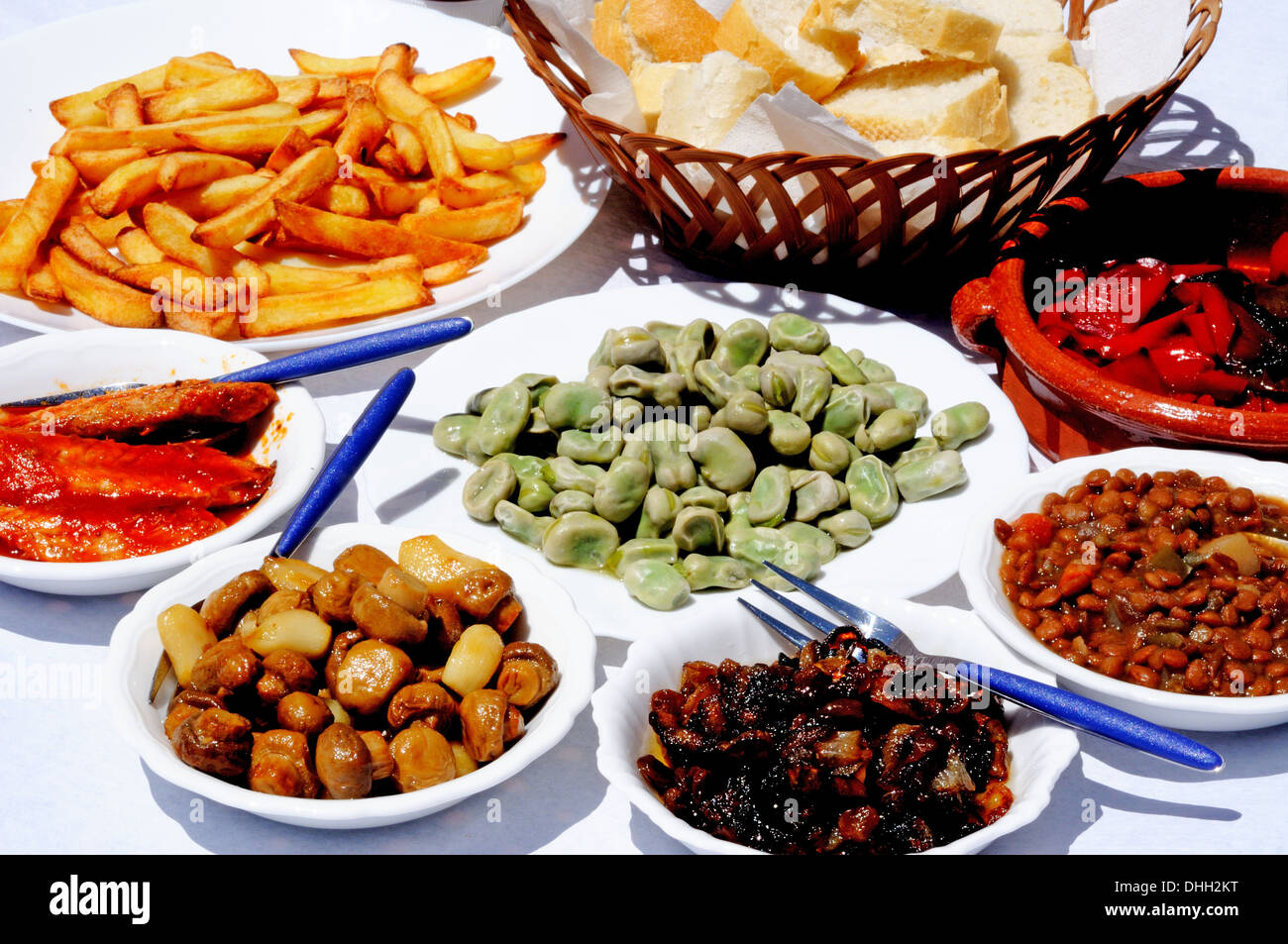 Spanish tapas selection of Sardines, broad beans, mushrooms, onions ...
