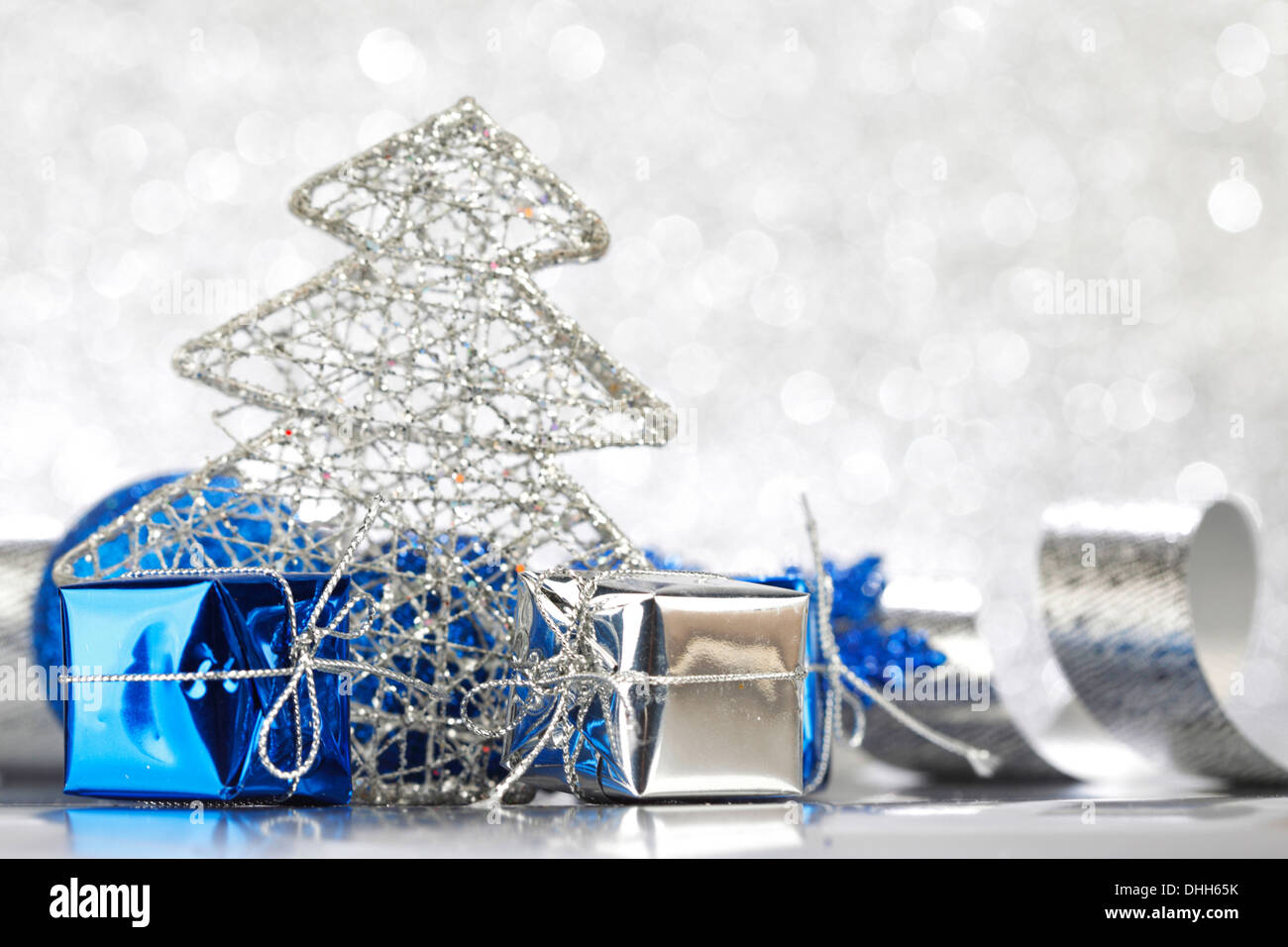 Christmas card with gifts and decoration on shiny silver background ...