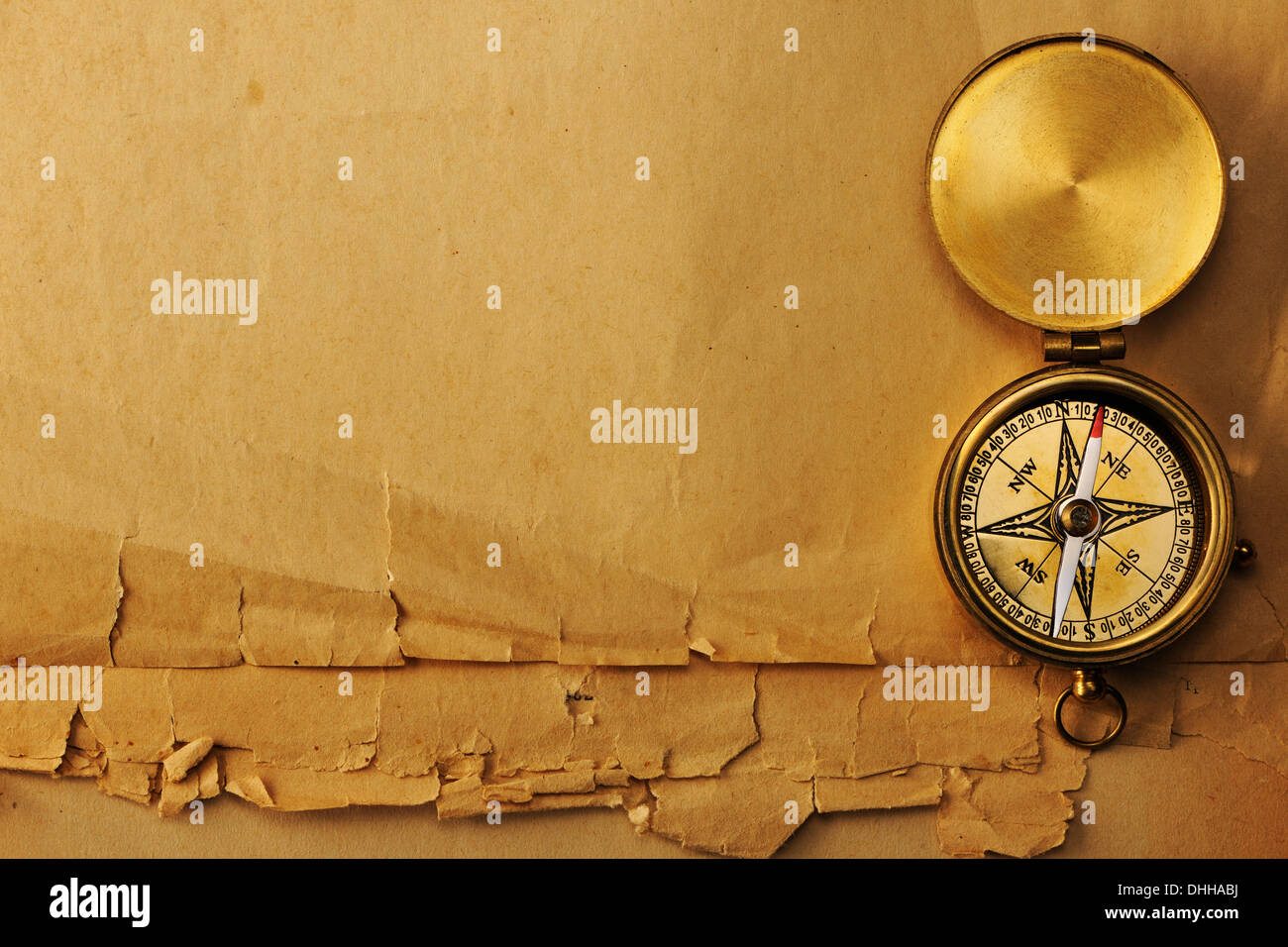 Antique brass compass over old background Stock Photo - Alamy