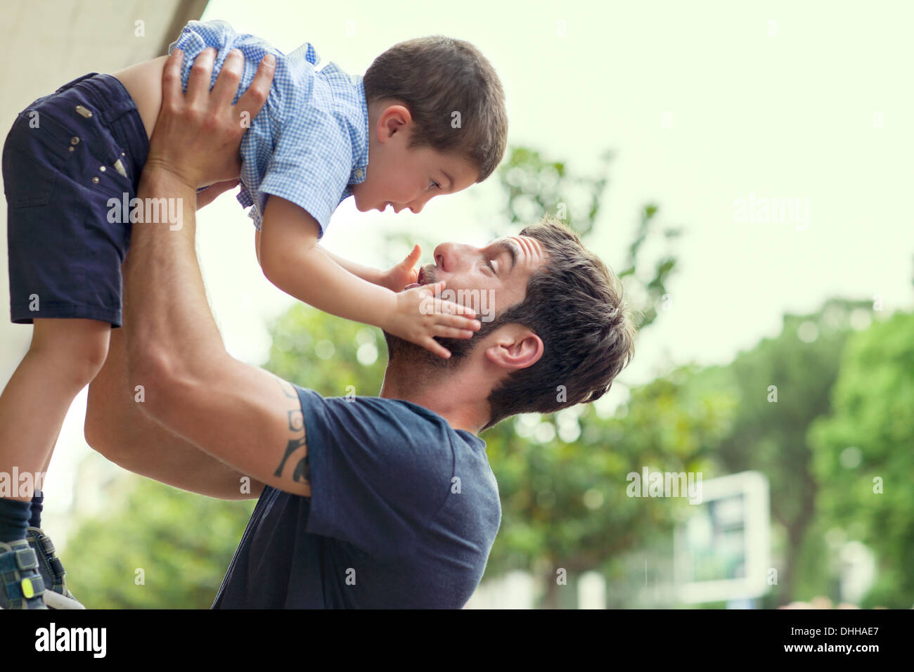 Father lifting son Stock Photo - Alamy