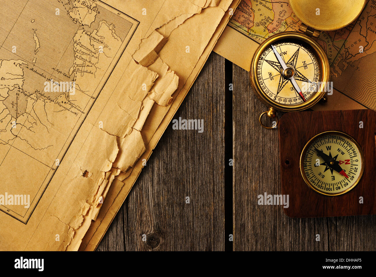Antique compass over old map Stock Photo - Alamy