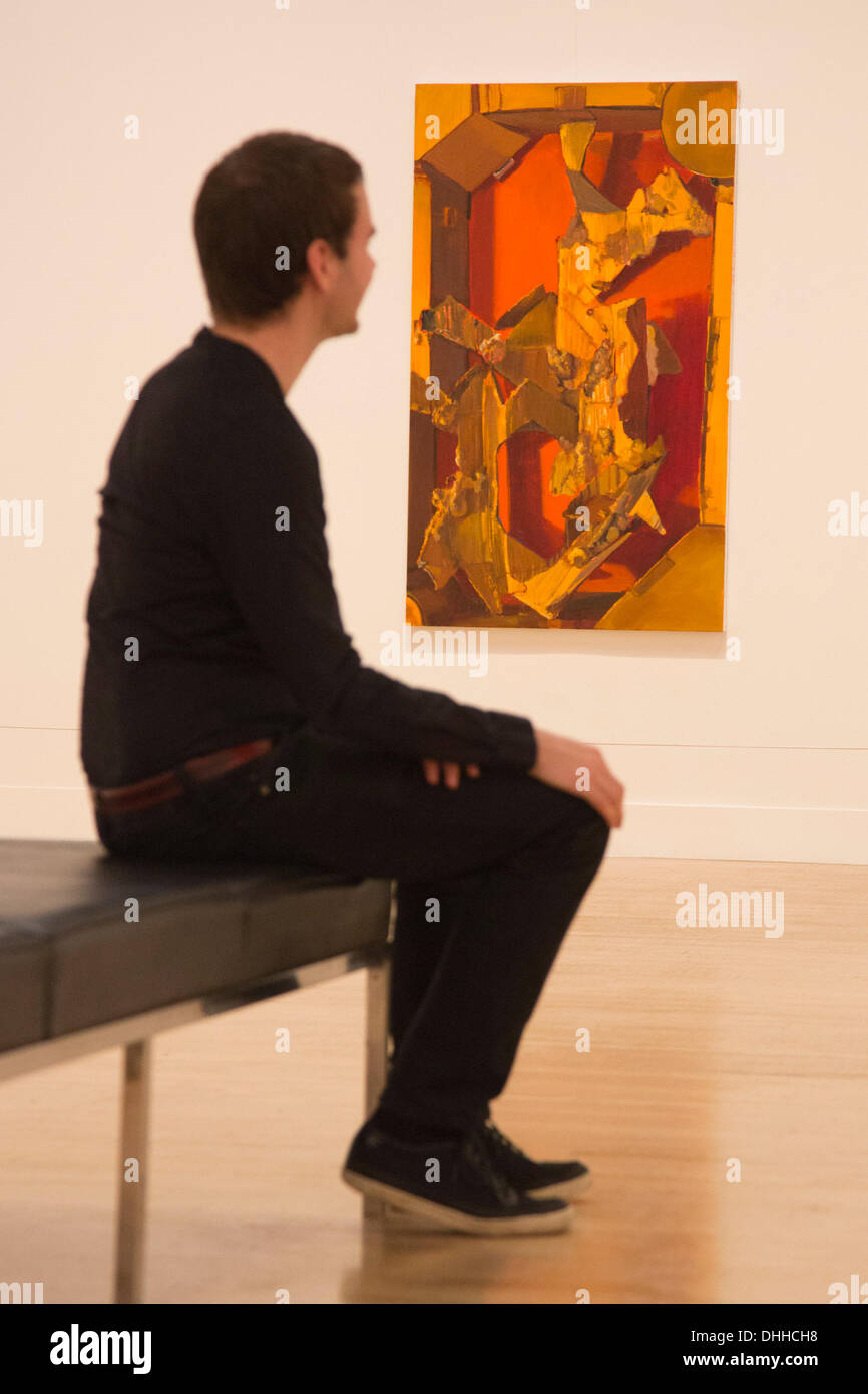 London, UK. 11 November 2013. Pictured: A museum worker sits in front ...