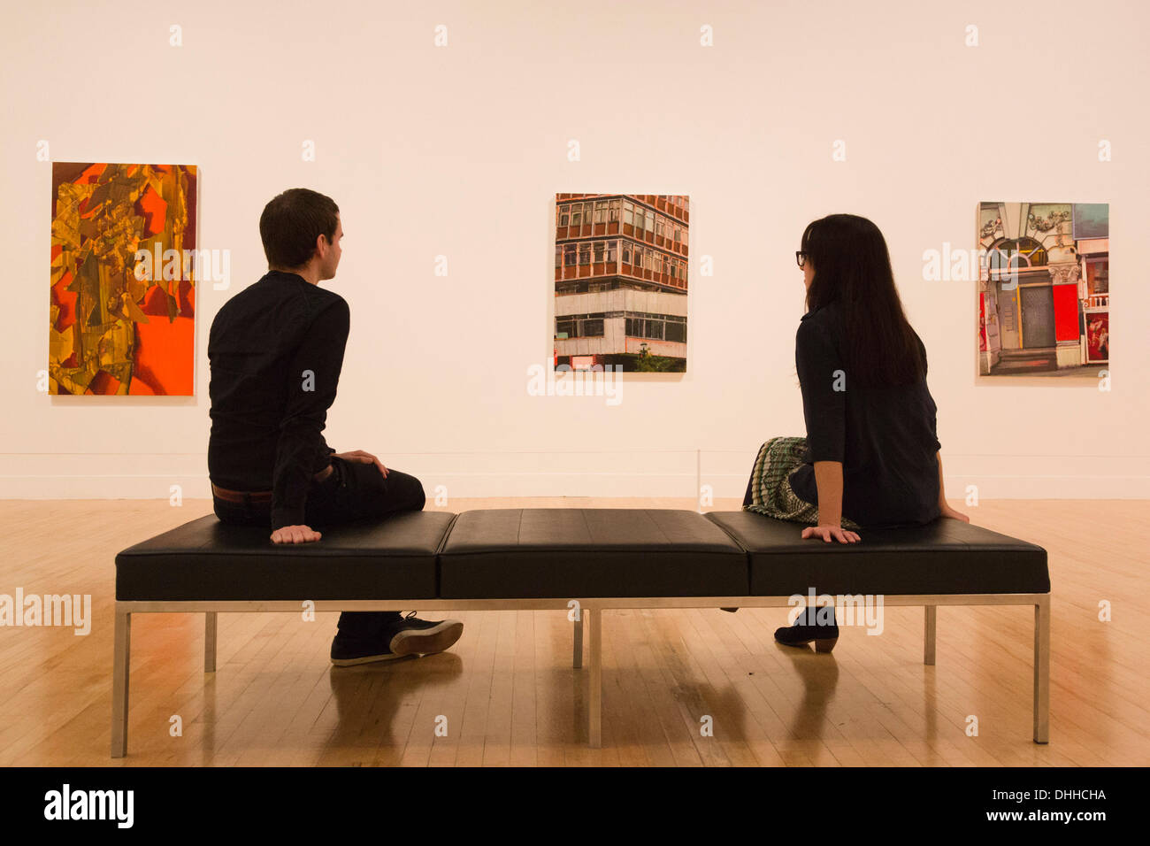 London, UK. 11 November 2013. Two museum workers sit in front of ...