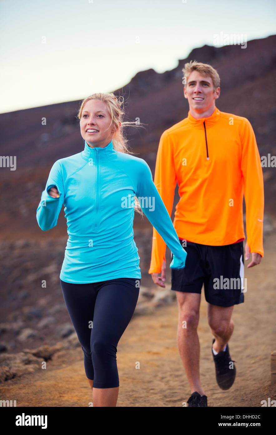 Fitness sport couple running jogging outside on trail Stock Photo - Alamy