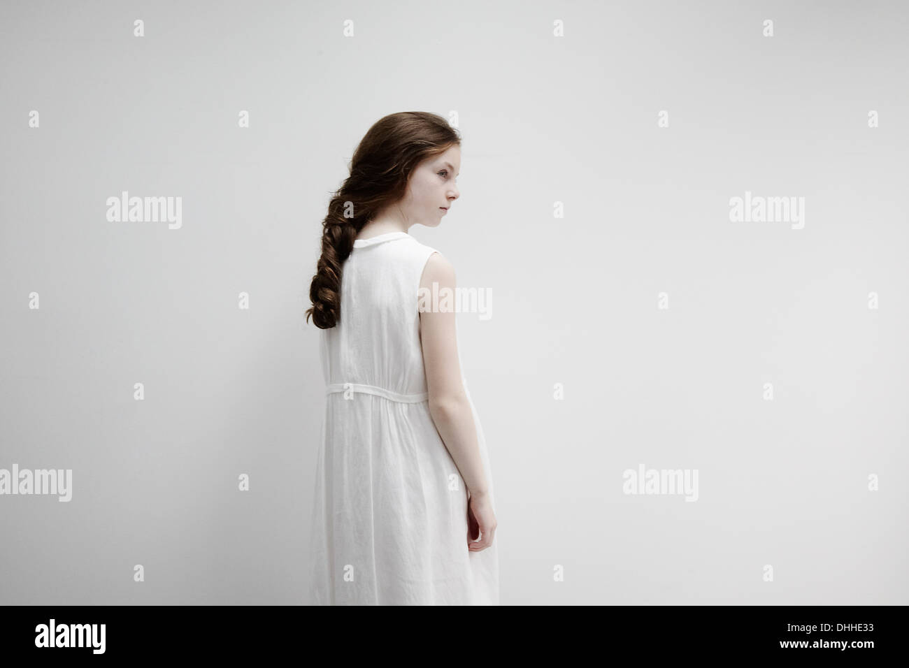 Girl posing sideways for camera Stock Photo - Alamy