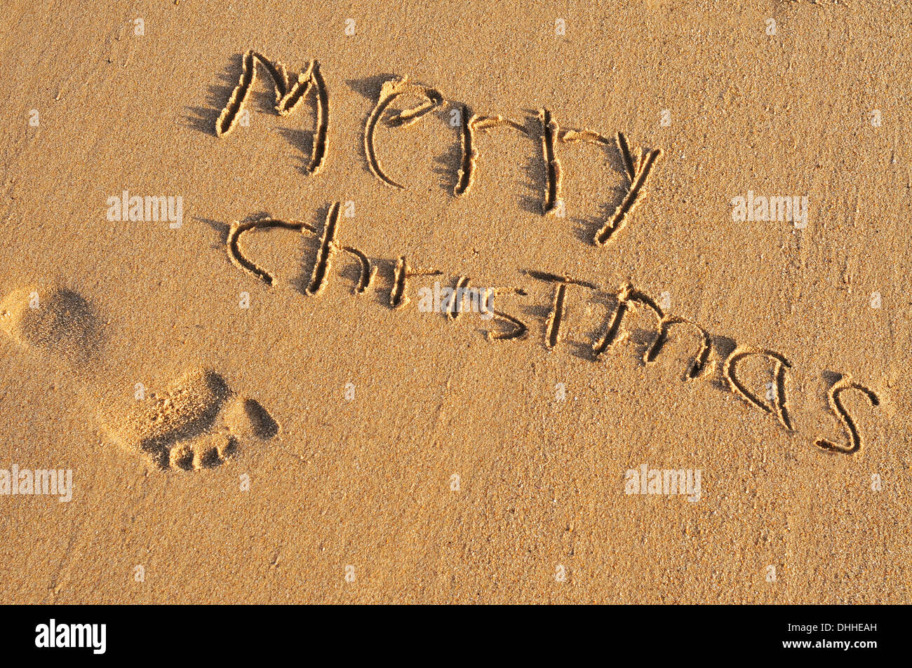 Merry christmas written on sand hi-res stock photography and images - Alamy