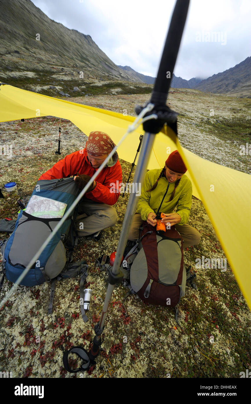 Hikers unpacking in tent Stock Photo - Alamy