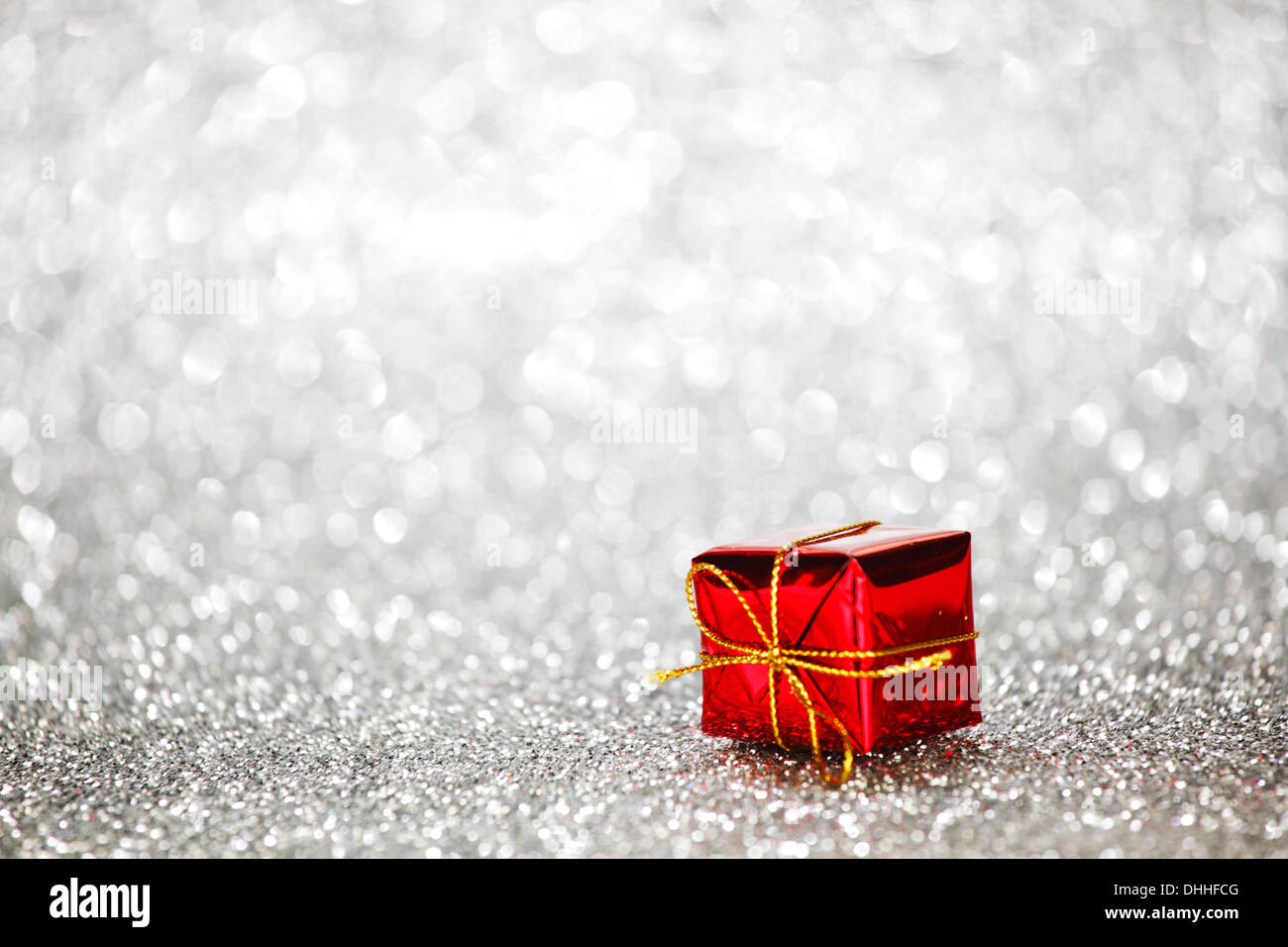 Gift box on glitter silver background Stock Photo - Alamy