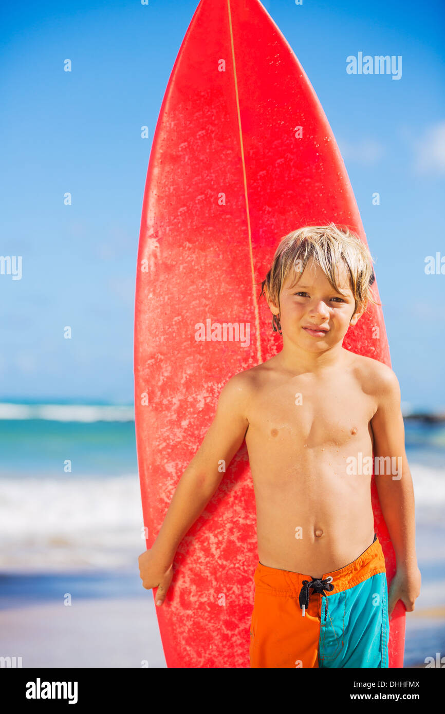 Young surfer, happy young boy at the beach with surfboard Stock Photo ...